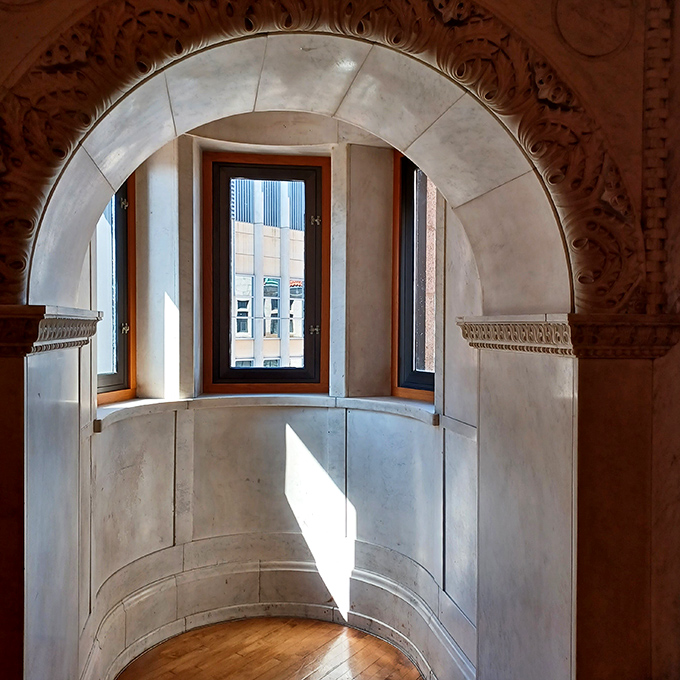 Sunlight streams through arched windows, creating the kind of natural spotlight that makes you feel like you're in a period film.