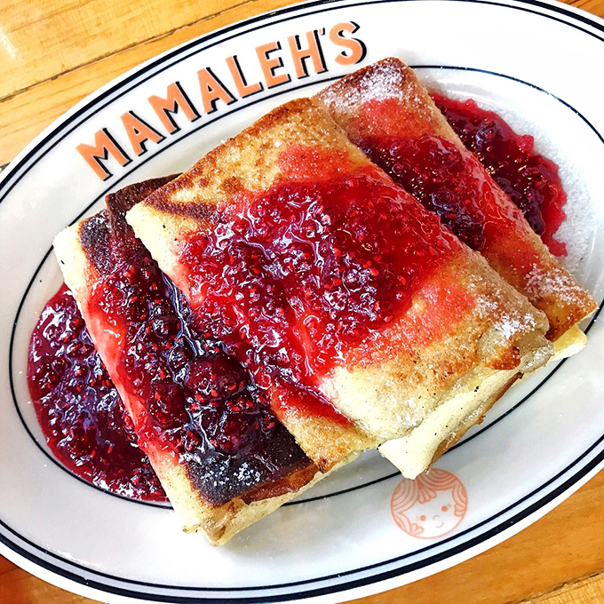 Blintzes bathed in ruby-red preserves&mdash;these delicate pancakes are what breakfast dreams are made of, dusted with powdered sugar like fresh snow.