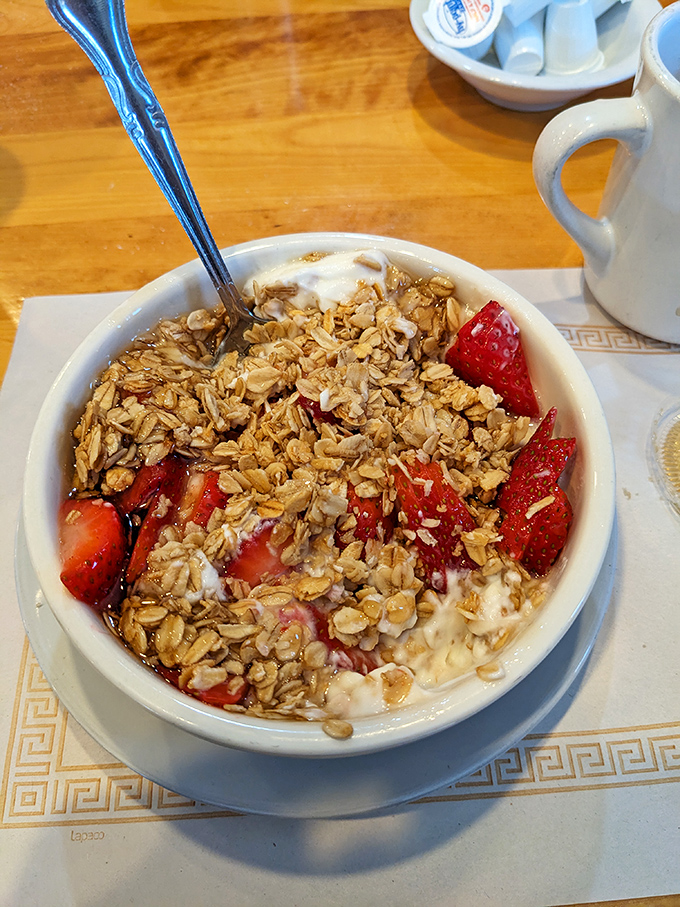The breakfast of champions – yogurt, granola, and fresh strawberries for those virtuous moments before you inevitably order a side of bacon anyway.