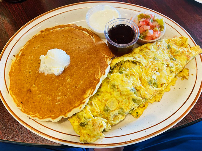 An omelet that's as big as your appetite, with a pancake sidekick that ensures you won't need lunch - breakfast perfection on a plate.
