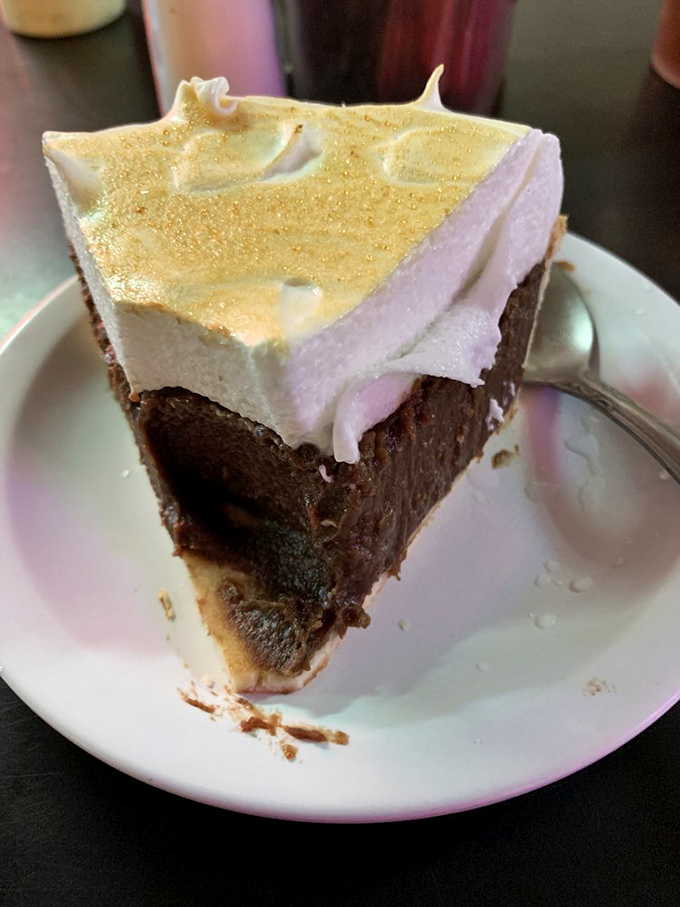 A slice of chocolate meringue pie that makes grown men weep – the sweet finale to a meal that's already legendary.