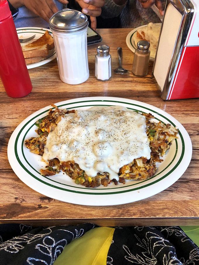 A skillet masterpiece under a blanket of gravy. When breakfast components unite with this much harmony, it's like the Avengers of morning meals.