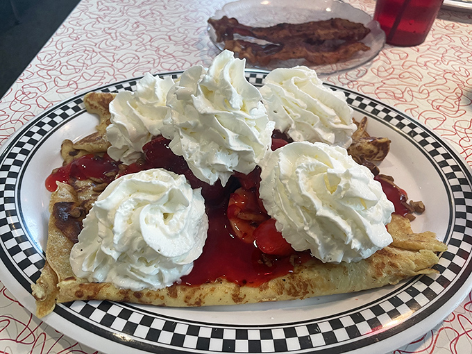 Dessert or breakfast? When the crepes are this good, topped with mountains of whipped cream and berry compote, such distinctions become deliciously irrelevant.