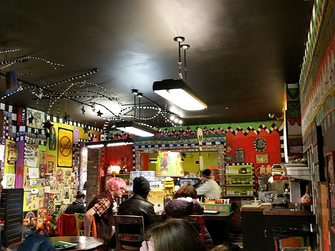 Every inch of wall and ceiling space tells a story, creating an atmosphere where even waiting in line becomes part of the experience.