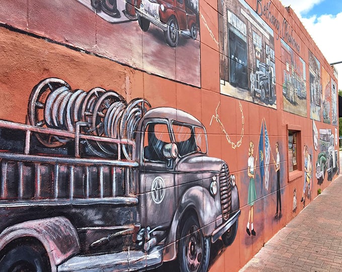 The exterior mural tells stories of heritage and tradition. Even the building itself refuses to be ordinary.