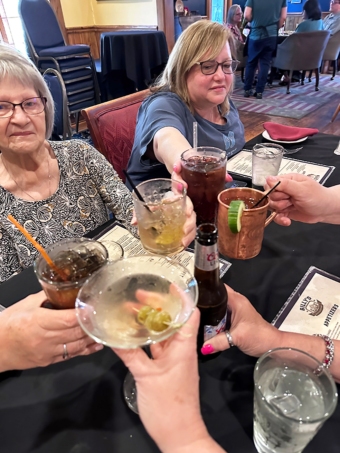 Toasting to good times with an array of drinks. Nothing says "celebration" quite like the satisfying clink of glasses over a black-clothed table at Billy's.