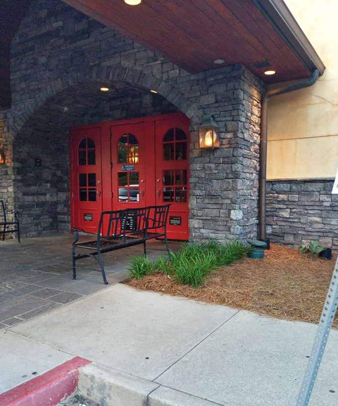 The welcoming red doors framed by natural stone say "yes, you've finally found it" &ndash; the entrance to your new favorite weekend ritual in Alpharetta.