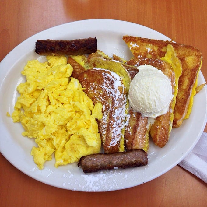 French toast that doesn't just flirt with decadence—it's in a full-blown relationship, complete with powdered sugar snowfall and a scoop of ice cream.