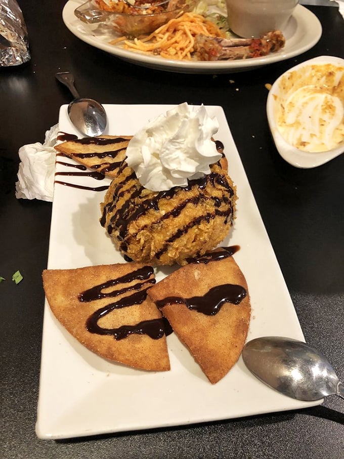 Fried ice cream that refuses to be ordinary—crisp exterior, melting interior, and chocolate drizzle performing a sweet finale to your meal.