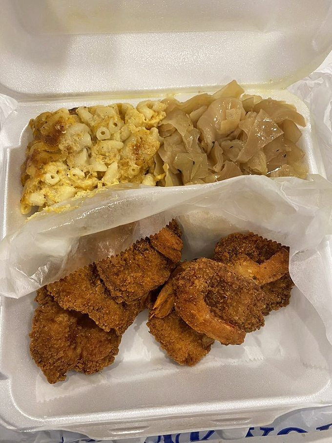 Crispy fried shrimp nestled beside mac and cheese and cabbage &ndash; a trio that hits every texture note in perfect harmony.