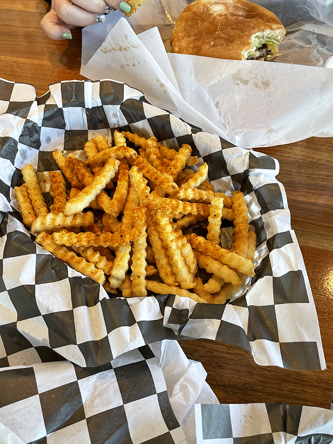 Crinkle-cut fries that achieve the impossible: crispy on the outside, fluffy on the inside, and somehow disappearing faster than you can say "just one more." 