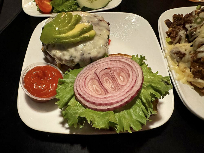 This burger, topped with avocado and served with perfect presentation, proves that heavy metal and fine dining aren't mutually exclusive concepts.