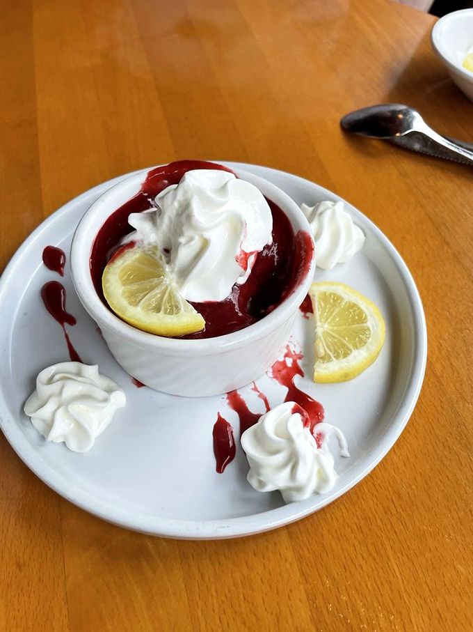 This vibrant berry dessert topped with fluffy whipped cream and fresh lemon slices offers you a sweet, refreshing end to dinner.