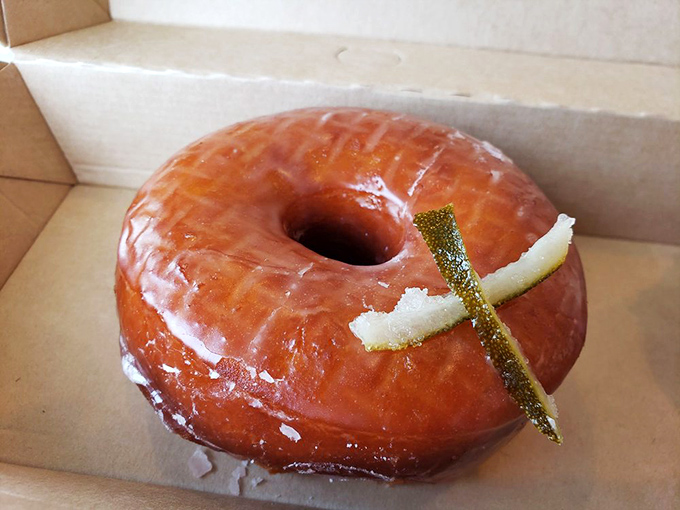 Not just another glazed donut – this citrus-adorned beauty has the confidence of something that knows it's about to be devoured.