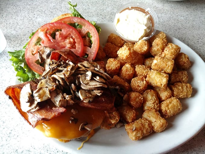 This isn't just a burger&mdash;it's a monument to mushroom magnificence with a side of golden tater tots that crunch like autumn leaves.