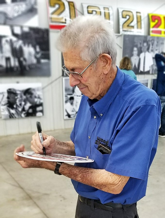 The maestro at work&mdash;Leonard Wood signing autographs with the same precision he once used to tune engines that outran the competition.