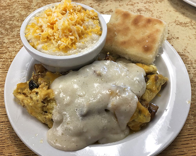 This isn't just breakfast&mdash;it's edible art. Cheese-topped perfection with a side of grits and biscuit&mdash;the holy trinity of Southern morning meals.