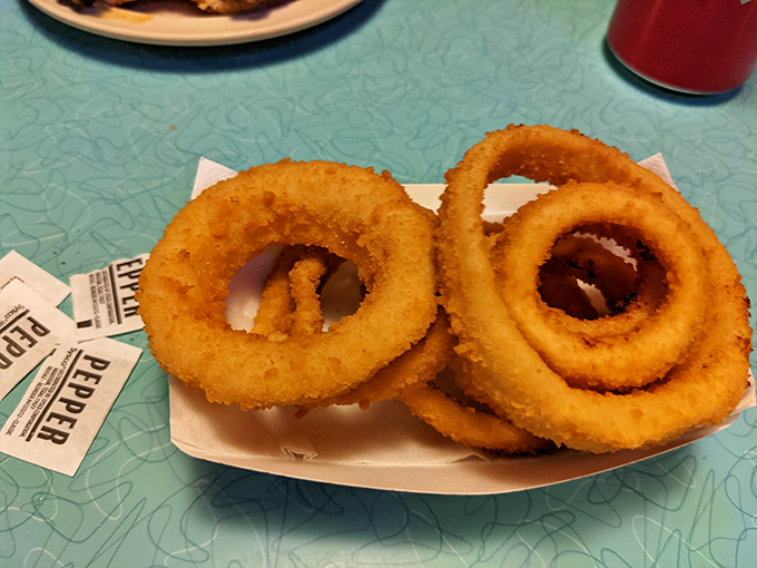 Golden, crispy onion rings stacked like delicious halos. If angels ate appetizers, they'd surely choose these perfectly fried circles of joy.