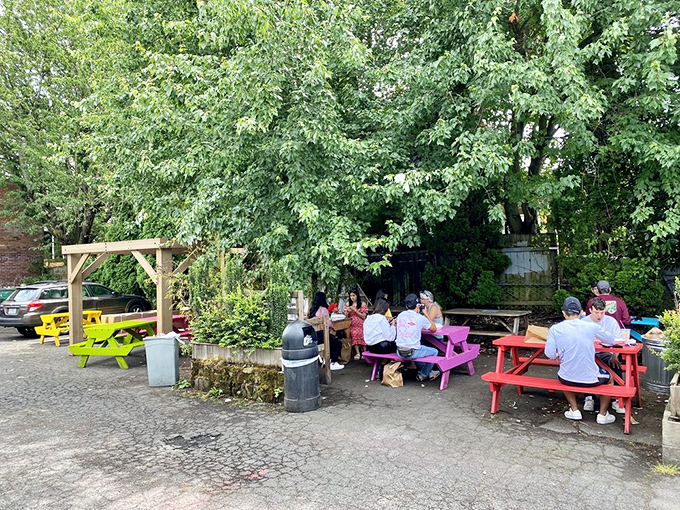 Colorful picnic tables under leafy trees create Portland's perfect outdoor dining spot&mdash;where waffle-lovers gather like a delicious support group.
