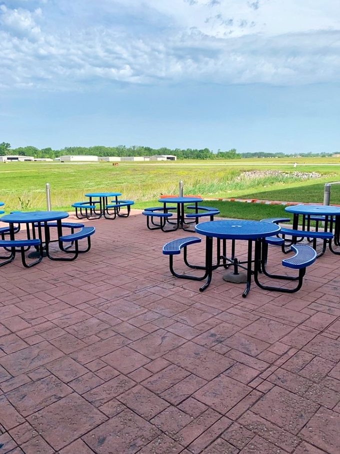 Outdoor seating with runway views. These blue tables offer front-row seats to aviation action while you digest that perfect diner breakfast.