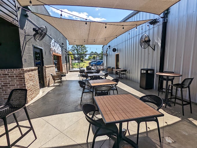 Shade sails and outdoor seating create the perfect coffee oasis. Not just a patio&mdash;it's an outdoor living room where conversations flow as freely as the coffee.