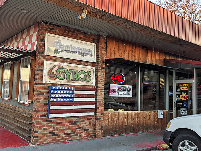 Beyond breakfast, Norma's exterior proudly announces its diverse menu offerings&mdash;from hamburgers to gyros&mdash;ensuring no appetite leaves unsatisfied.