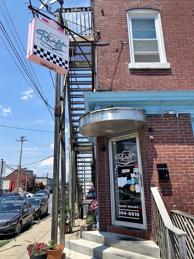 That retro sign beckoning from the brick building is like a lighthouse for hungry travelers—promising refuge and satisfaction on West Liberty Street.