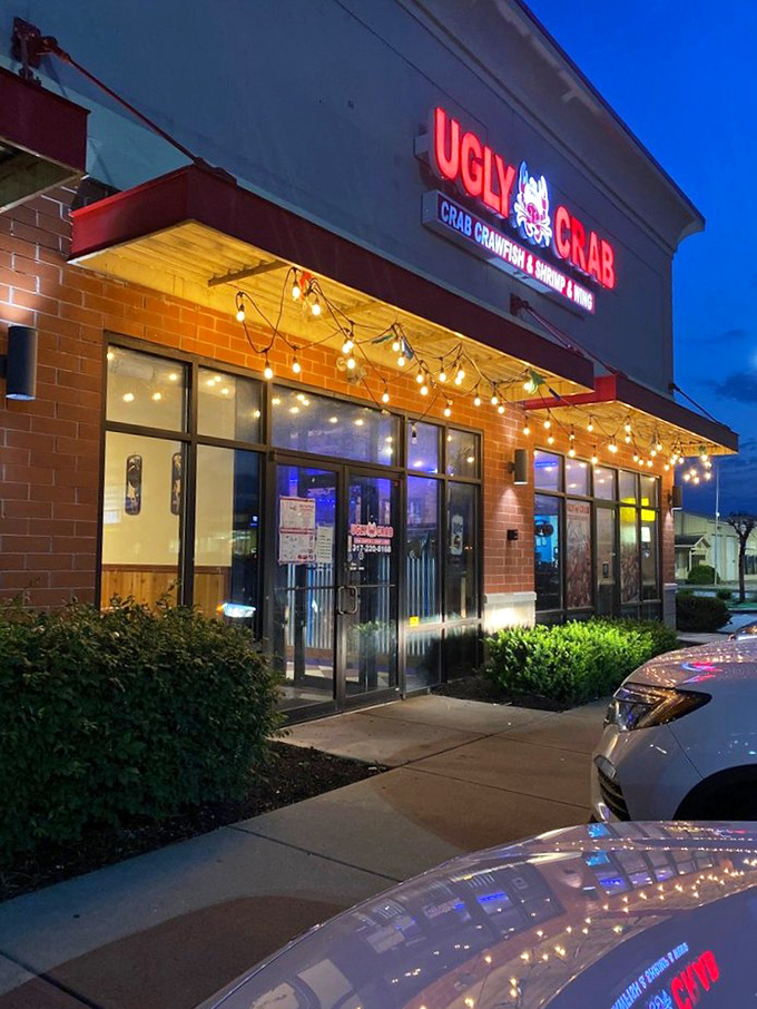 As evening falls, Ugly Crab's exterior transforms into a beacon of seafood possibility, string lights promising delicious adventures within.