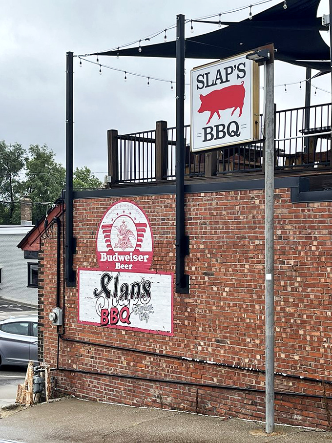 The sign stands as a beacon to hungry travelers: salvation in the form of perfectly smoked meat lies within.