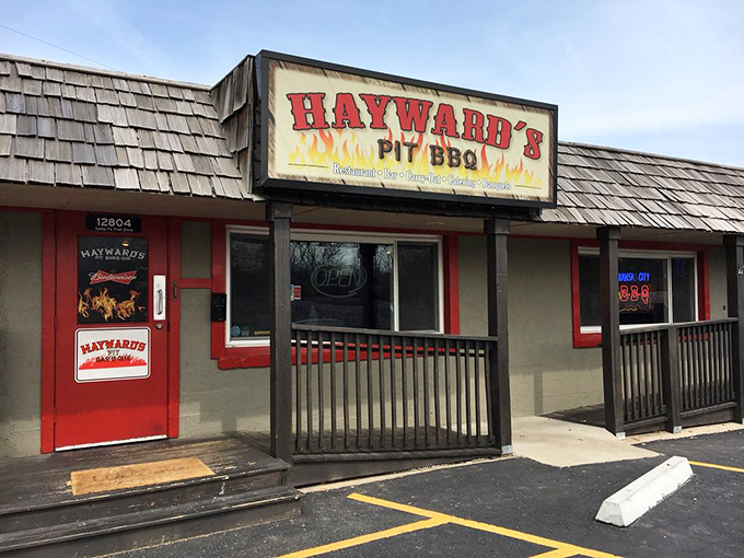 The sign promises pit BBQ, and inside they deliver. Like a barbecue lighthouse guiding hungry souls to smoky salvation in suburban Shawnee.
