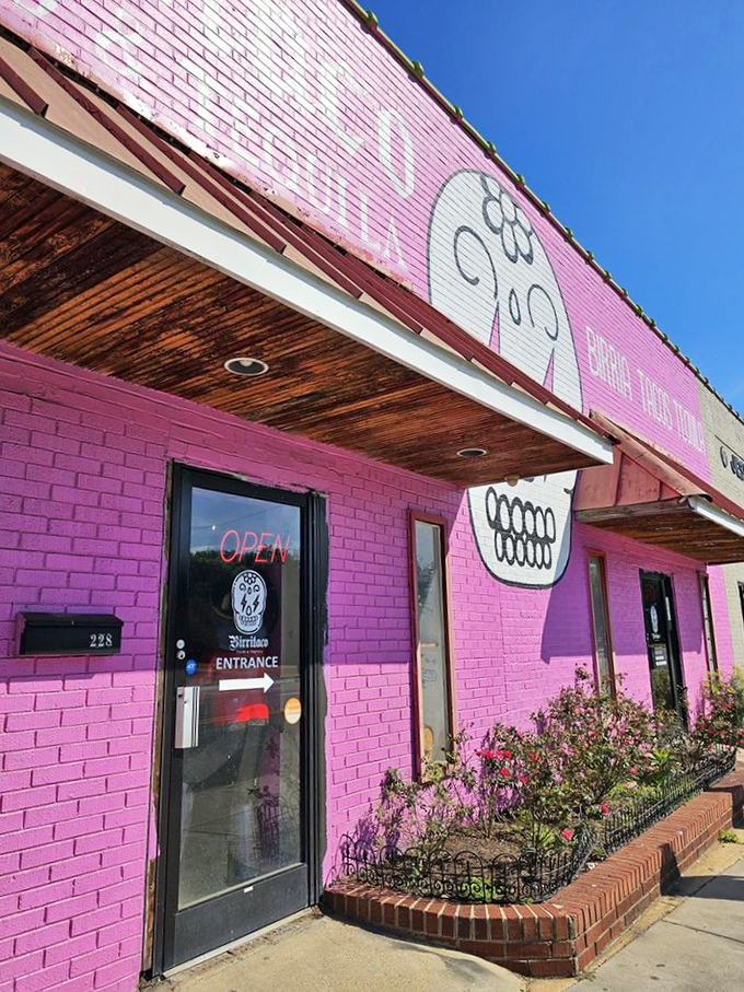 Even in bright daylight, that pink exterior with its sugar skull logo stands as a roadside attraction that delivers on its vibrant promise.