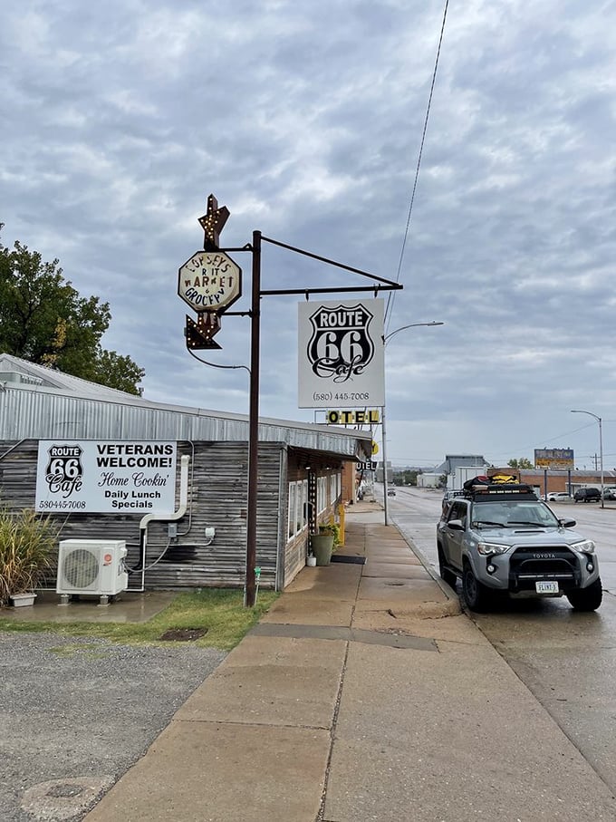 The iconic Route 66 shield sign stands sentinel against Oklahoma skies, a beacon for road-weary travelers seeking authentic tastes of American highway culture.