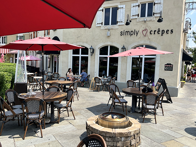 The outdoor seating area with red umbrellas and stone flooring is where summer brunches turn into afternoon-long affairs that nobody wants to end.