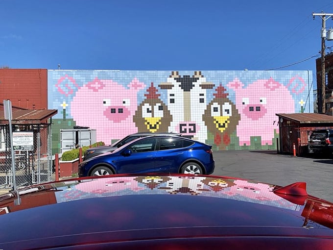 Even the parking lot mural celebrates the holy trinity of barbecue: pigs, cows, and chickens. A playful reminder of the delicious sacrifices made inside.