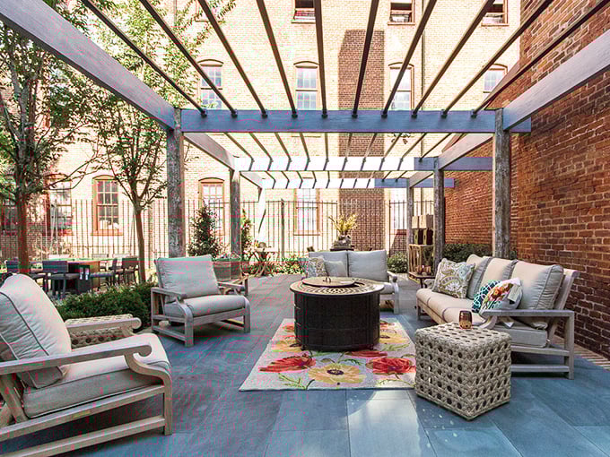 Outdoor living spaces reach new heights of comfort with cushioned seating that transforms brick courtyards into open-air living rooms under Virginia skies.