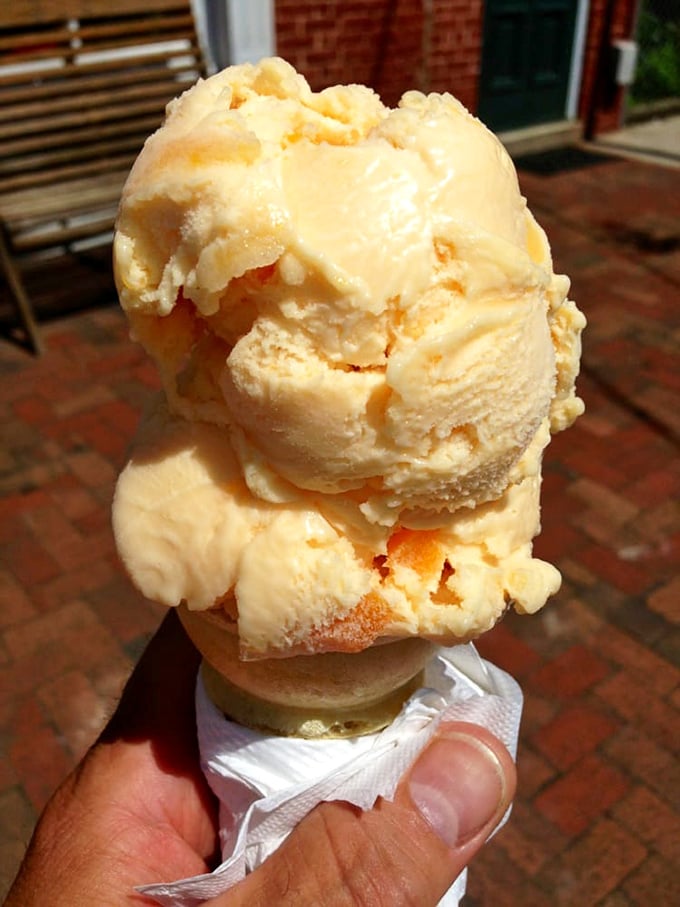 Peach ice cream on a waffle cone&mdash;summer's perfect equation. The napkin isn't just practical&mdash;it's catching memories that would otherwise melt away.