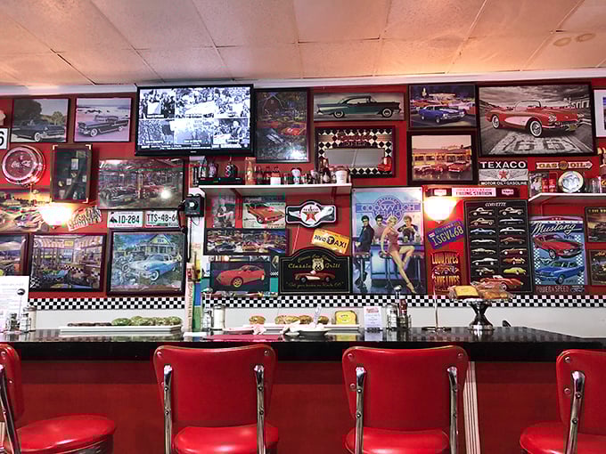 Car culture meets food culture on these walls. Every framed piece tells a story of chrome, horsepower, and an America that believed bigger was always better.