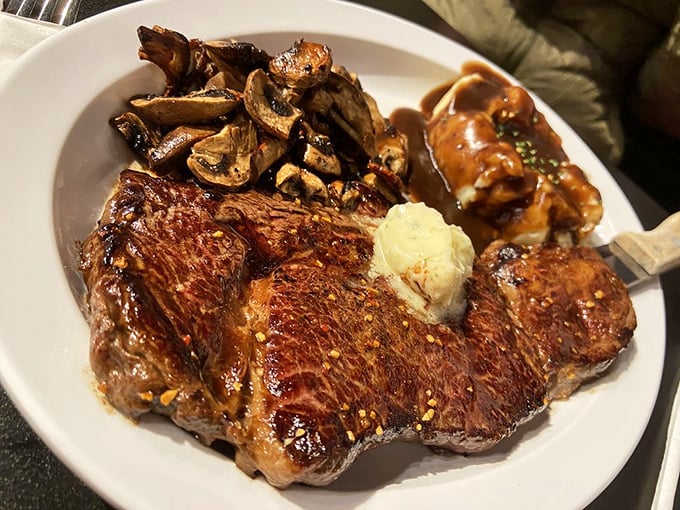 A rib eye steak that's living its best life, accompanied by mushrooms that have found their perfect purpose in this world.