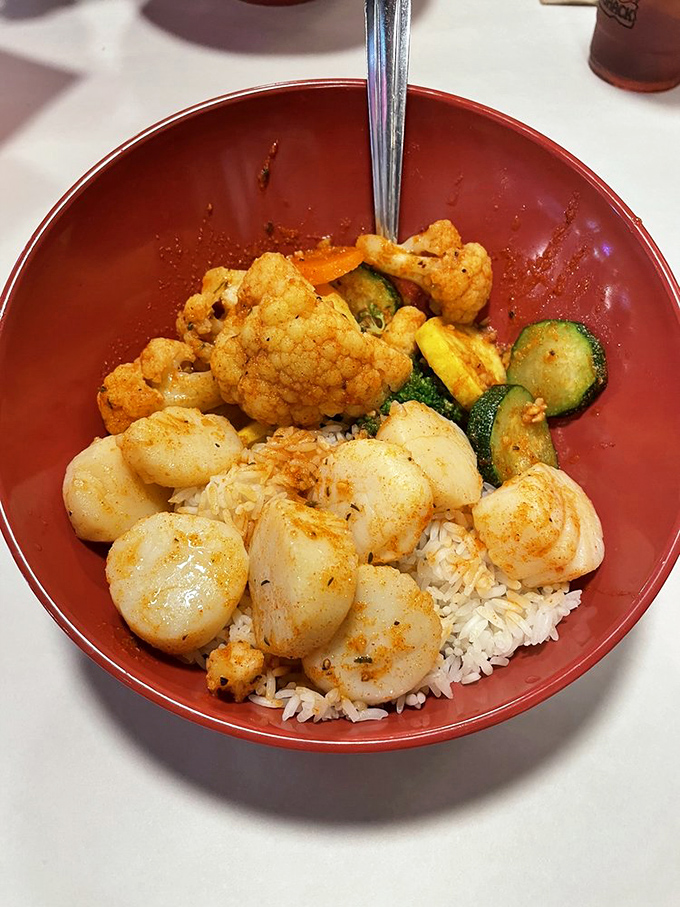 A bowl that tells a story of perfect harmony&mdash;plump scallops, tender vegetables, and rice ready to soak up every last drop of flavor.