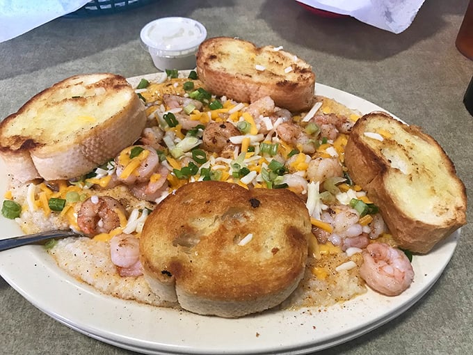 Shrimp and grits elevated to art form&mdash;where plump seafood meets creamy cornmeal cushioned by buttery garlic bread for the perfect Southern trifecta.