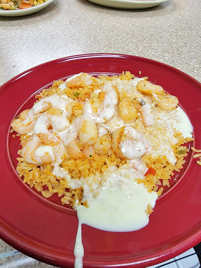 Shrimp and cheese sauce dancing across Spanish rice &ndash; a performance so captivating you'll want to give it a standing ovation before devouring it.
