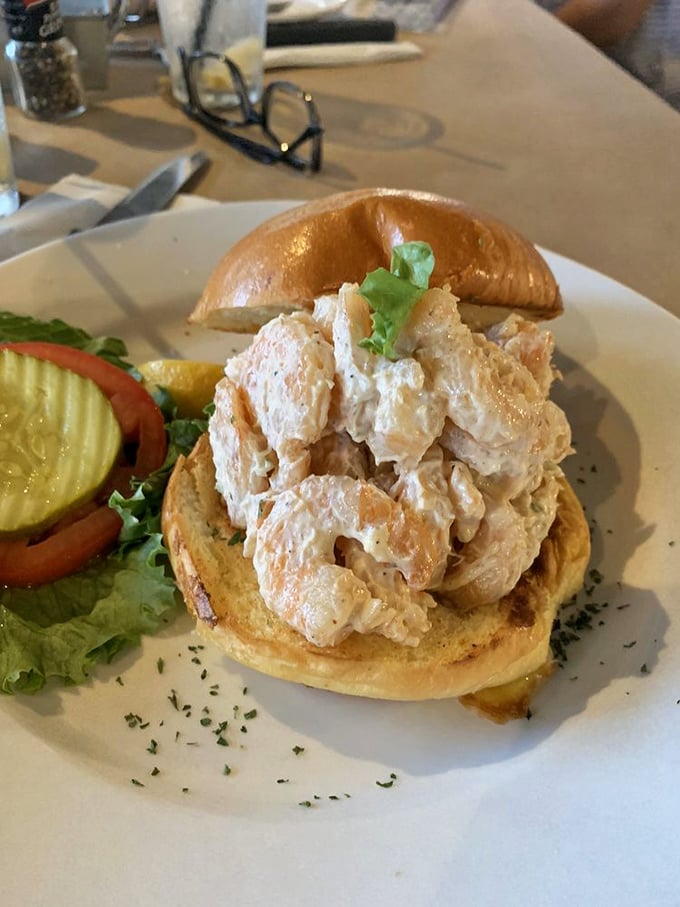 A shrimp salad sandwich so generously stuffed, it requires both hands and possibly a strategy meeting before the first bite.