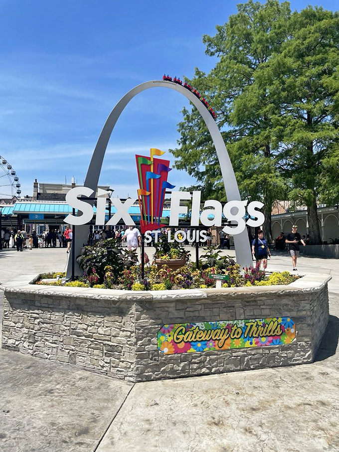 The iconic entrance sign with its mini Gateway Arch welcomes visitors to Missouri's premier collection of gravity-defying engineering experiments.