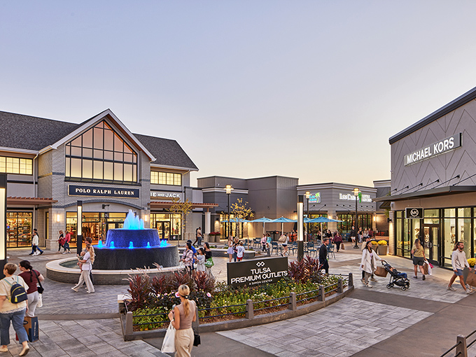 The central plaza with its fountain creates a moment of retail serenity, where shoppers pause to admire their purchases before diving back in.