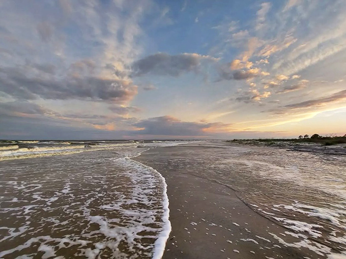 Sunset alchemy on Nanny Goat Beach. As day bids farewell, the retreating tide captures fragments of sky, creating a golden pathway that seems to lead straight to paradise.