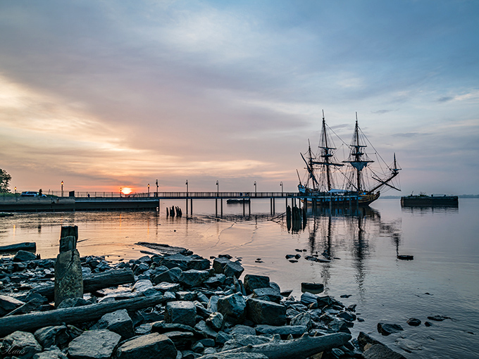 A tall ship silhouetted against the sunset creates the kind of postcard moment that makes smartphone photographers feel like Ansel Adams on vacation.