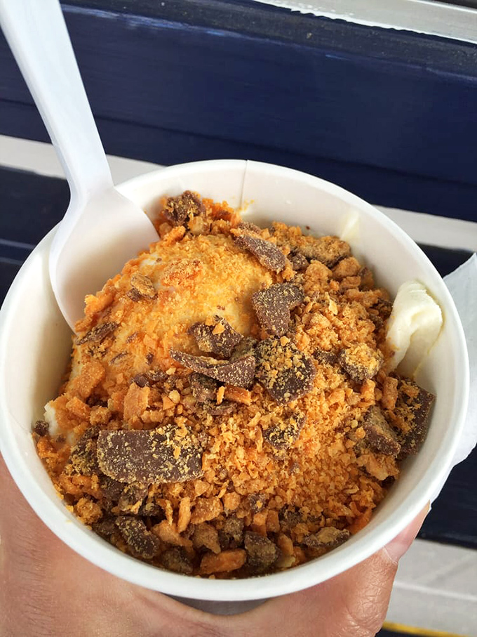 Vanilla custard topped with crushed Butterfinger creates a textural symphony that makes spoons everywhere feel purposeful.