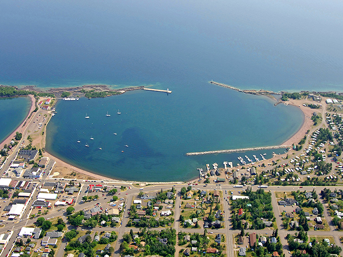 From above, Grand Marais reveals its perfect horseshoe harbor—a natural sanctuary that has sheltered travelers and dreamers for generations.
