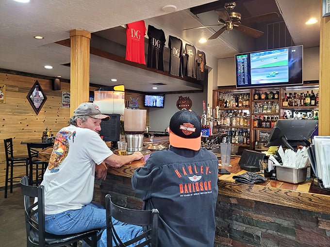 The bar where strangers become regulars and regulars become friends. Derby Grille merchandise hanging above tells you this isn't just a meal&mdash;it's membership.