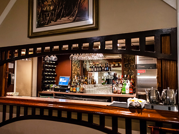Not just a bar but a liquid library with polished wood shelves, where bottles stand like leather-bound classics waiting to tell their stories.